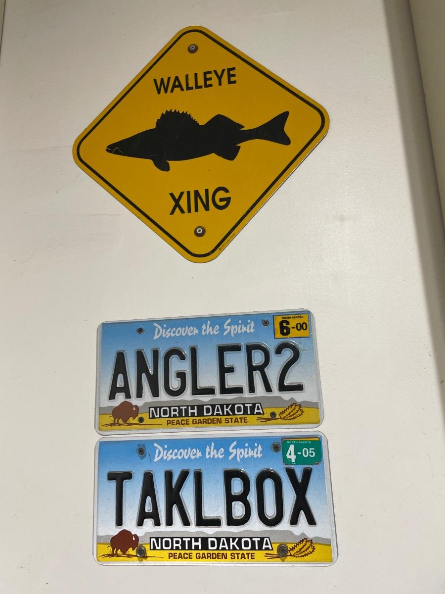 Fishing license plates and walleye crossing sign | EstateSales.org