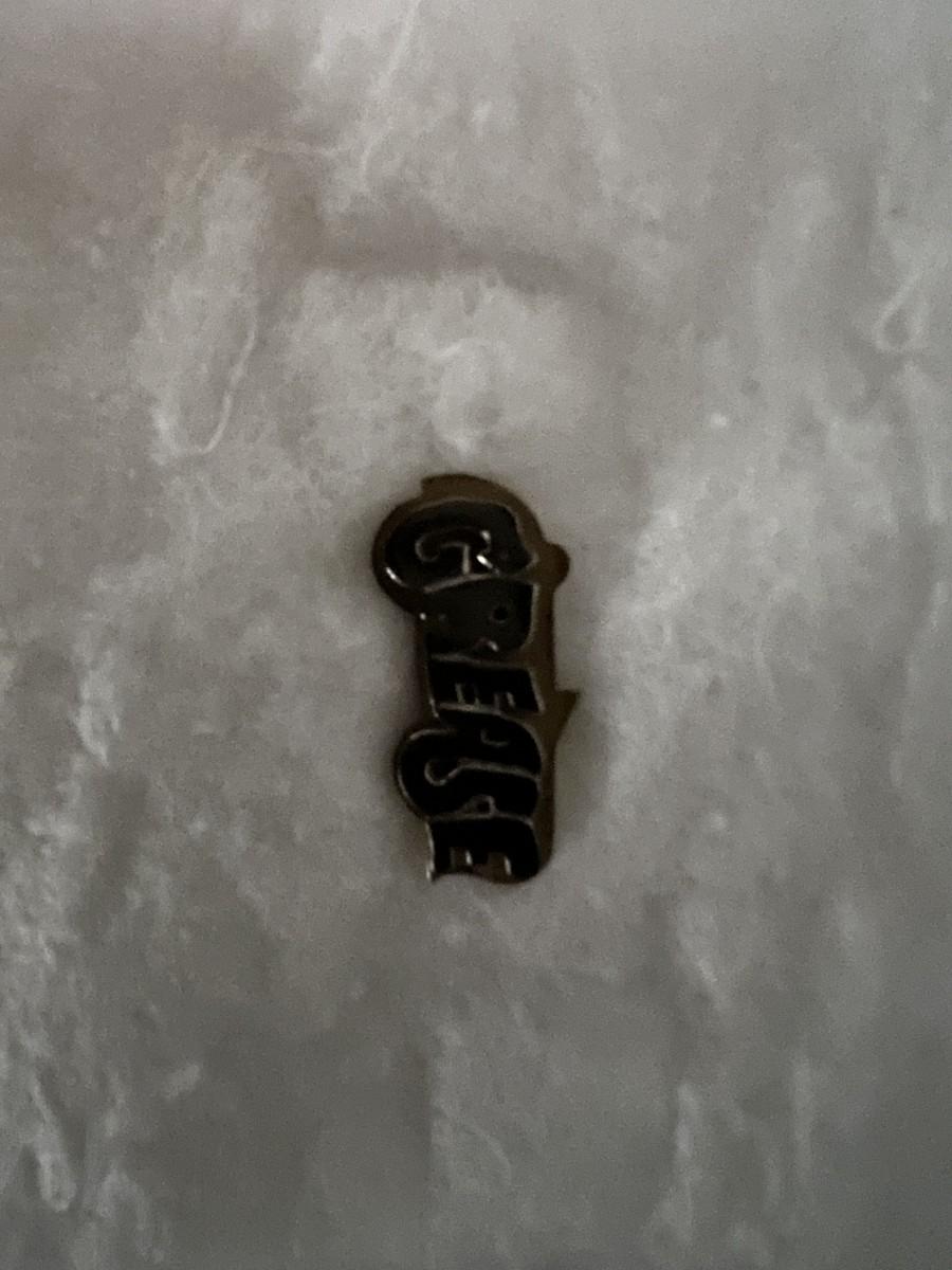 Grease original metal lapel pin | EstateSales.org