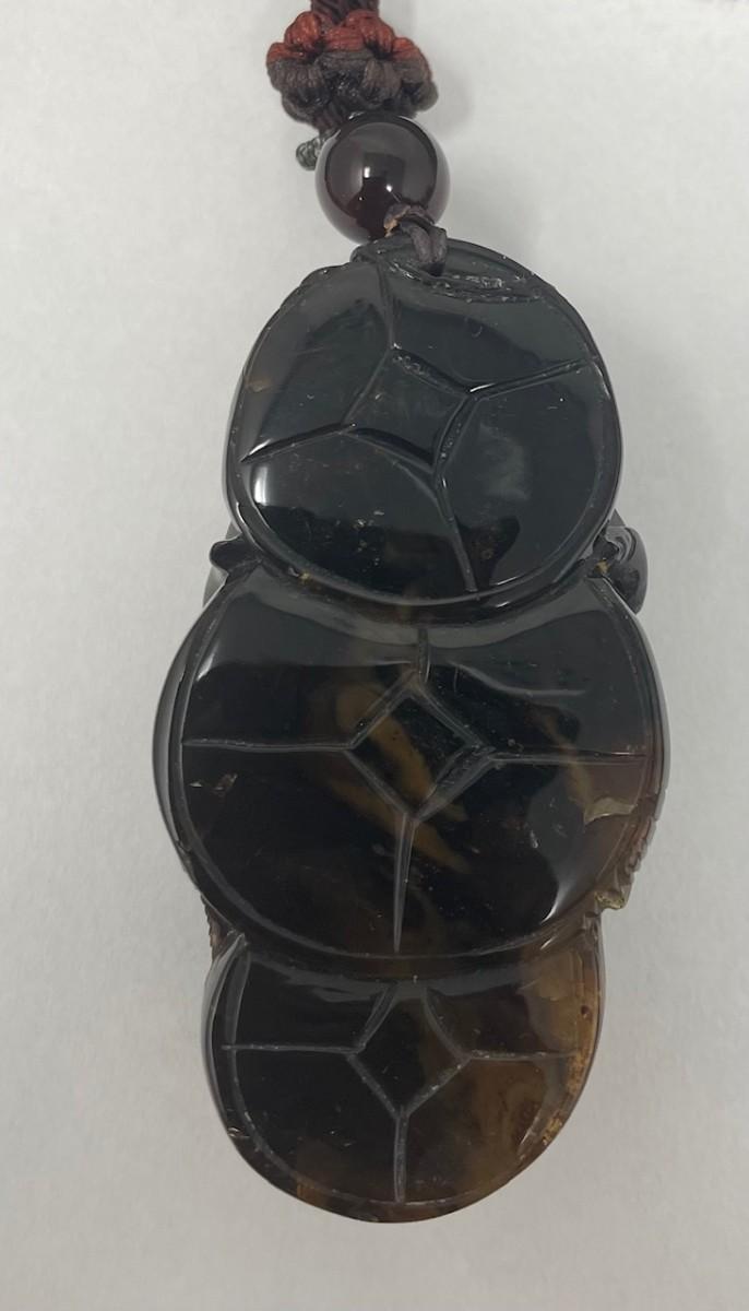 Antique Chinese Amber Pendant | EstateSales.org