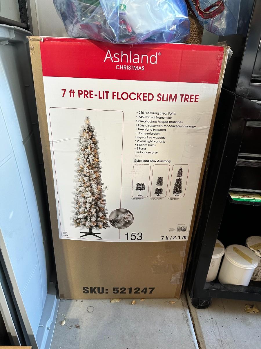 7ft. Pre-lit Flocked Slim Tree | EstateSales.org