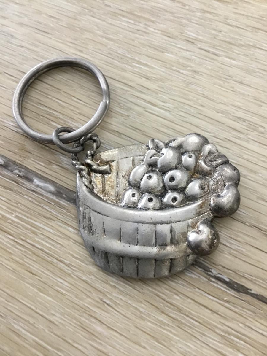 Silver tone apple bucket keychain used | EstateSales.org