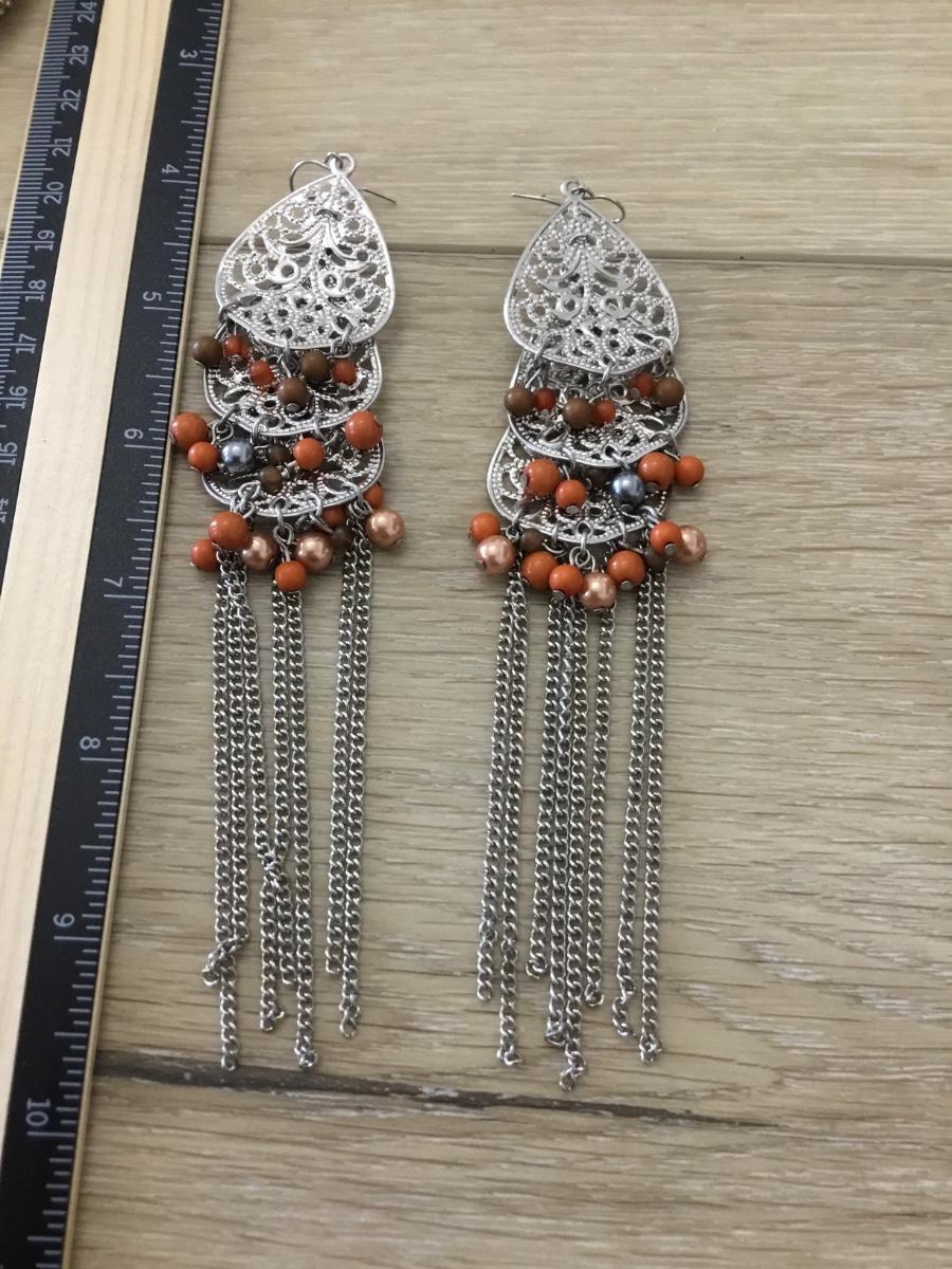 Silver tone long orange tassel chain earrings | EstateSales.org