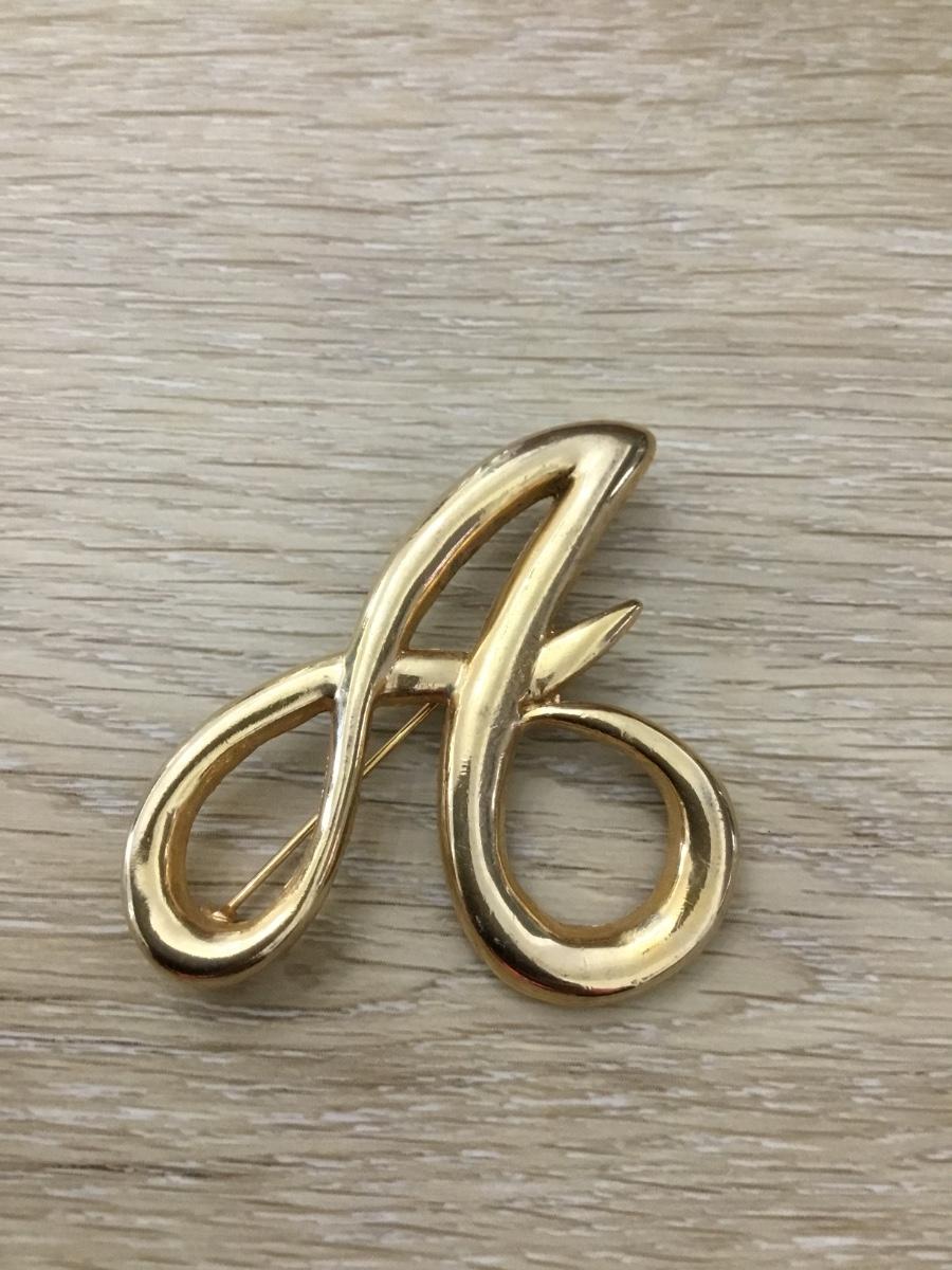 Gold tone letter A pin | EstateSales.org