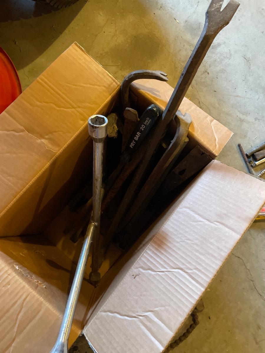 Box of pry bars, and tire iron | EstateSales.org