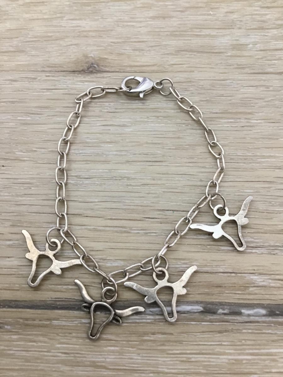Silver tone bull charm bracelet | EstateSales.org