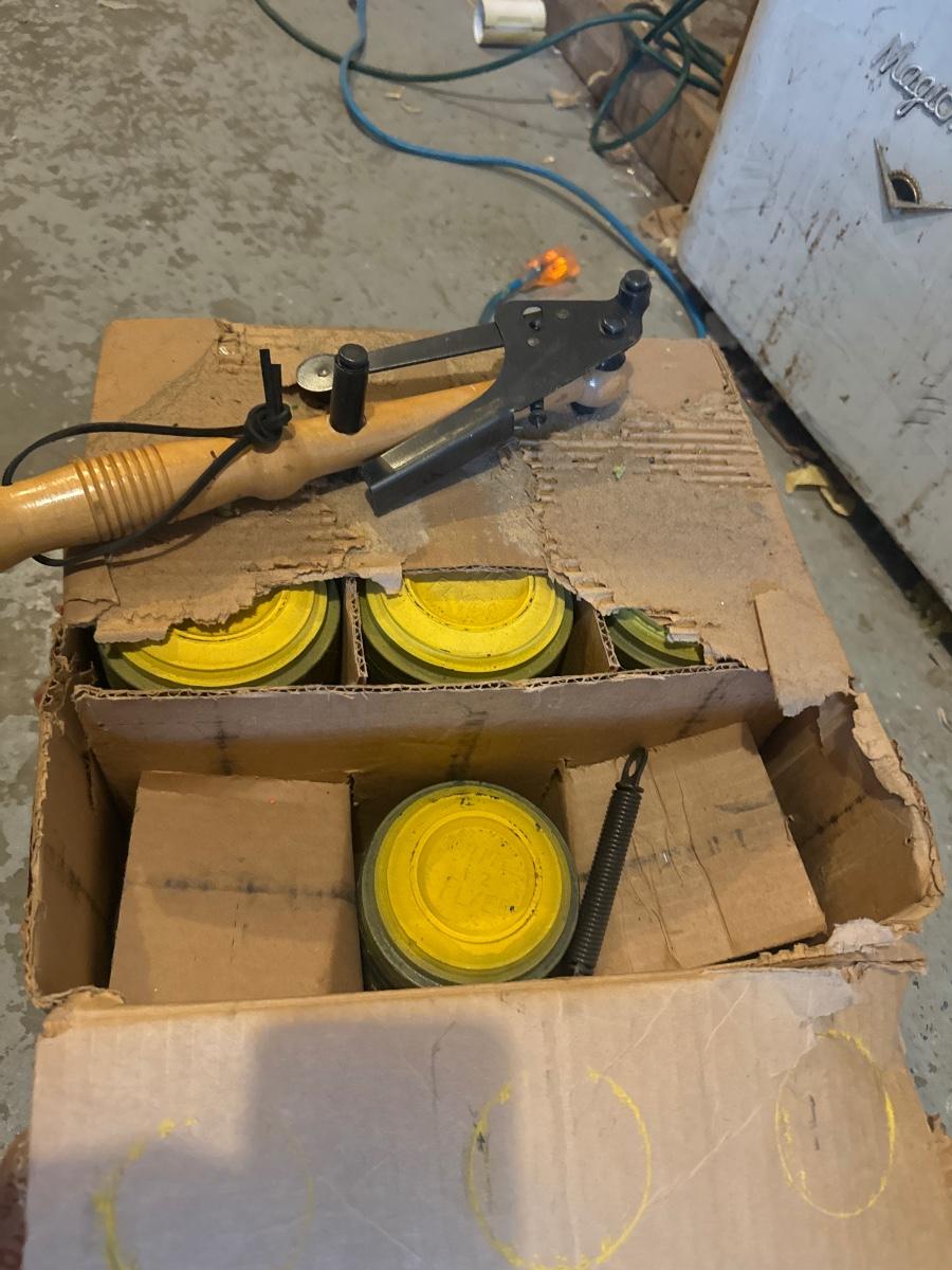 A box of clay pigeons with tool | EstateSales.org