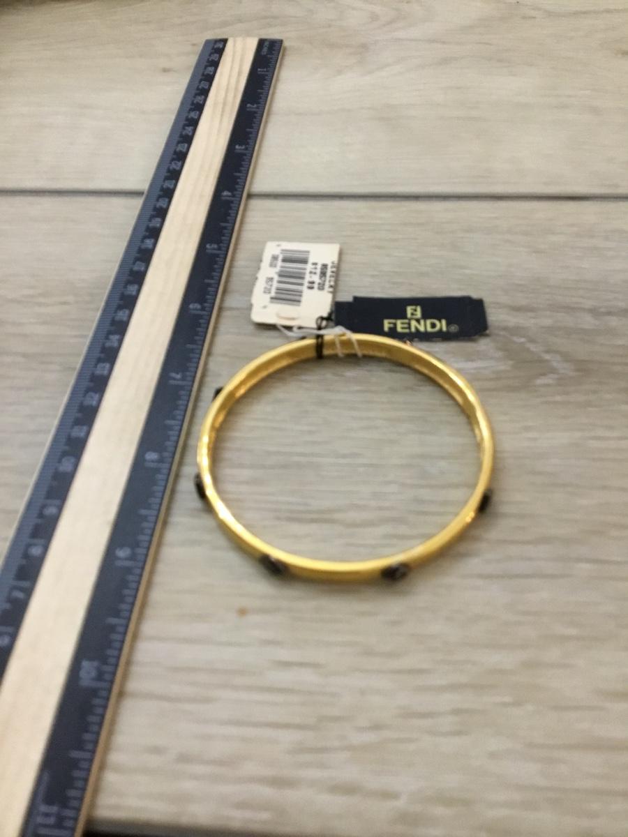 Gold tone Fendi bangle | EstateSales.org