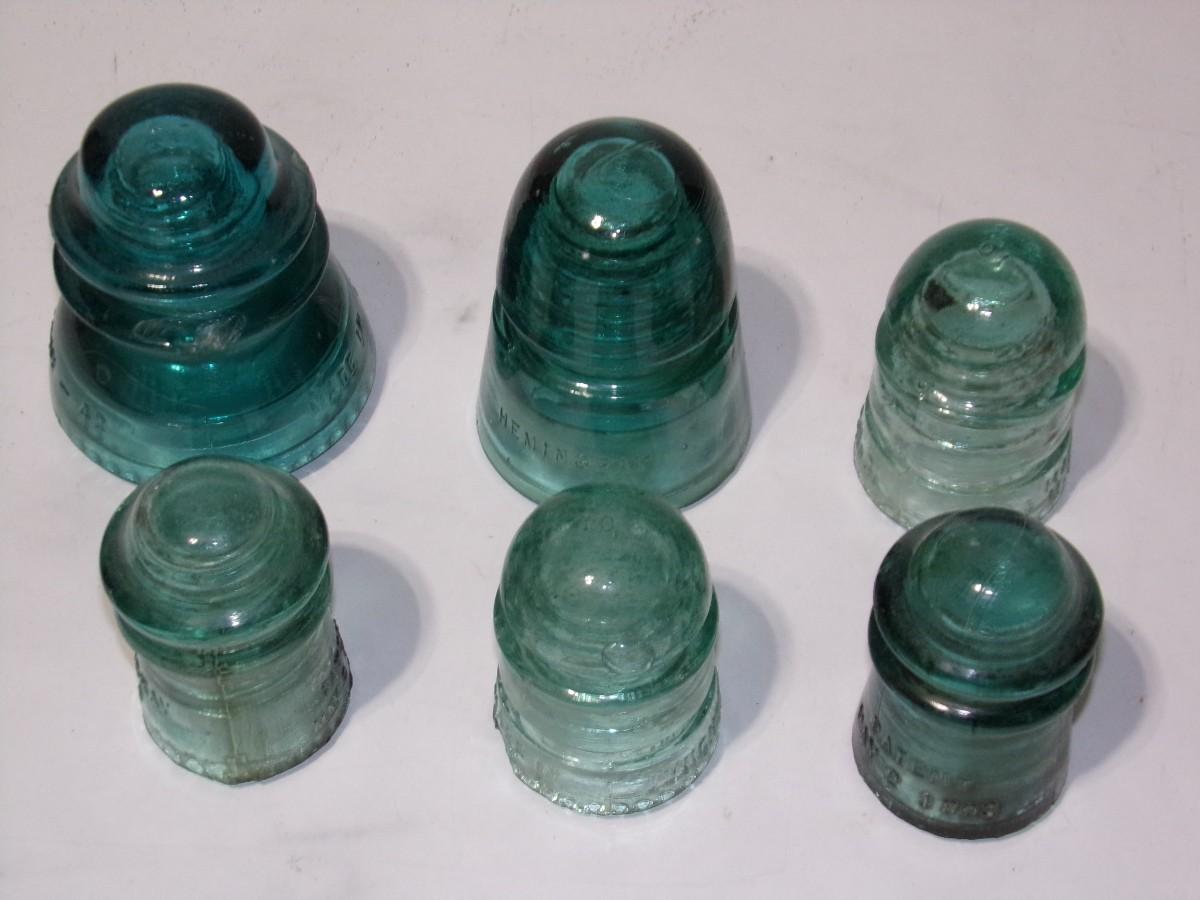 Lot of 6 green glass insulators | EstateSales.org