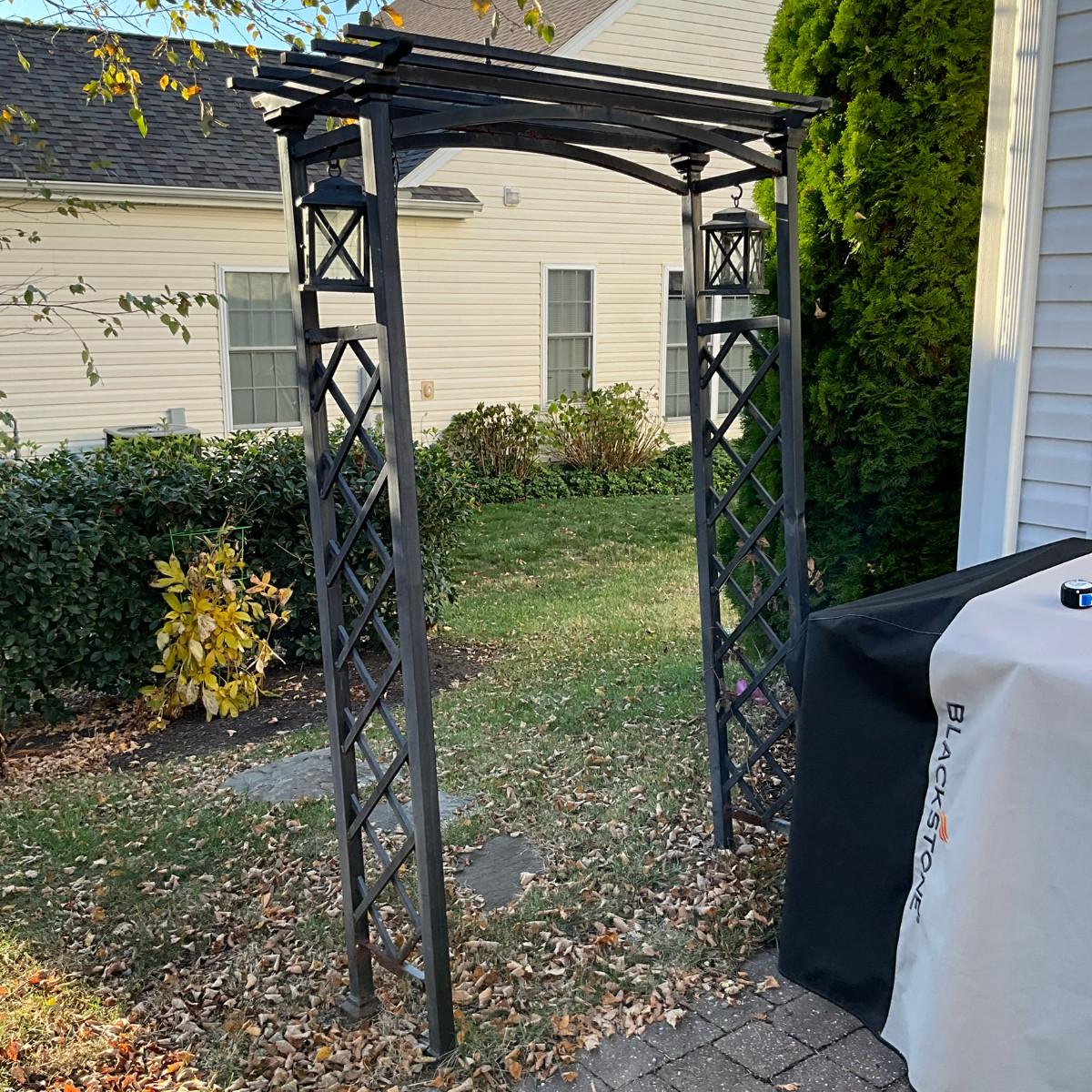 391 Black Metal Lattice Arbor With Two Lanterns | EstateSales.org
