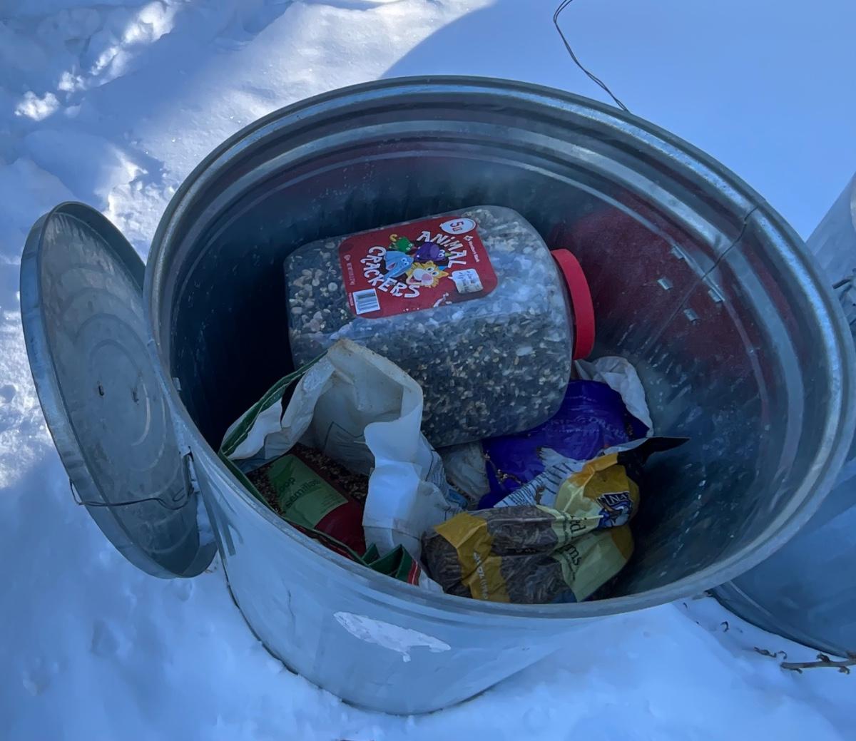 Can and bird feed in animal crackers container | EstateSales.org