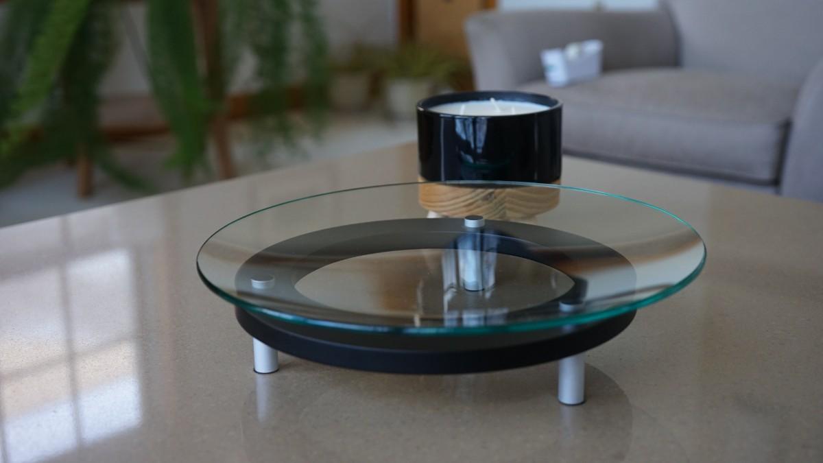 Contemporary bevelled glass round display plate on metal holder and ...
