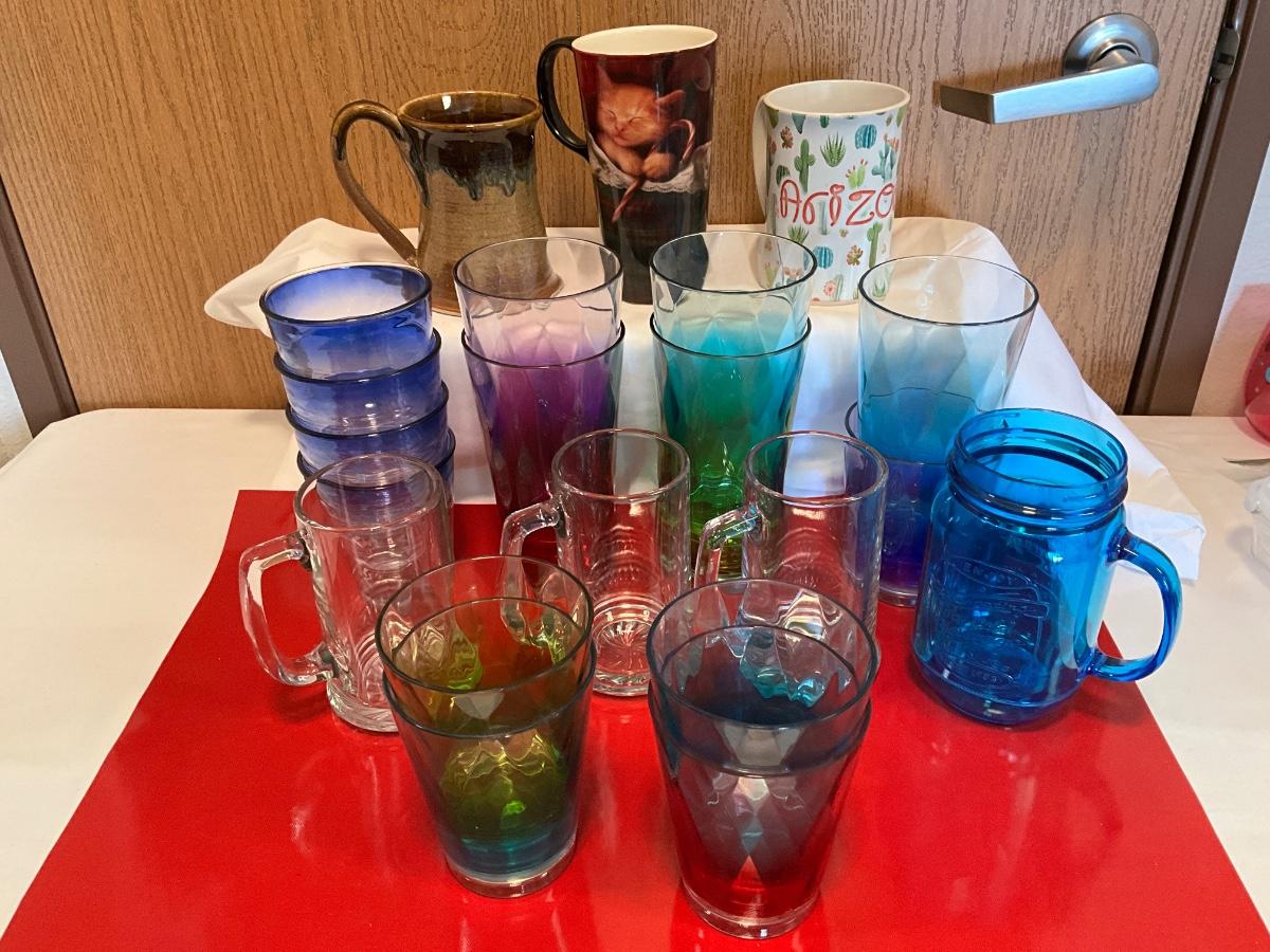 Variety of hard plastic glasses, glass beer mugs, coffee mugs ...