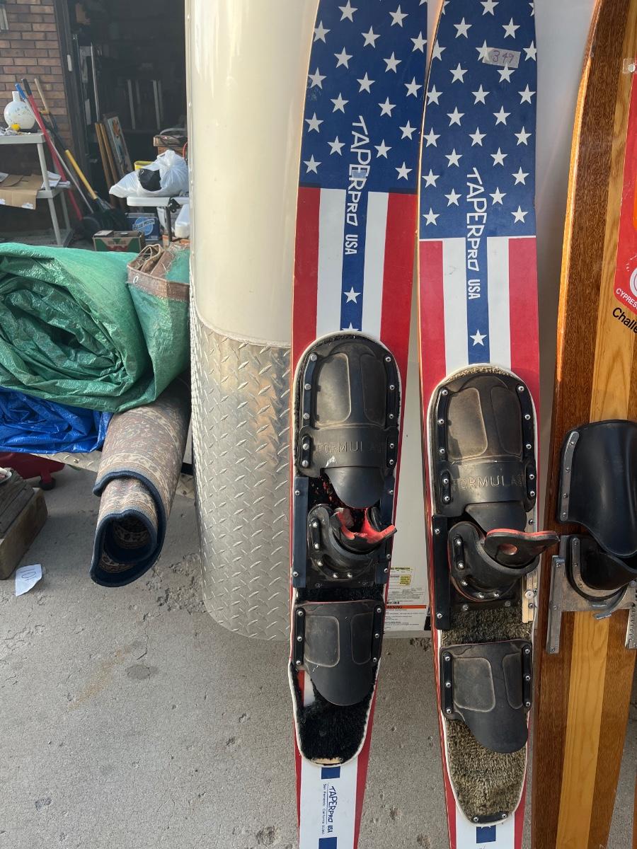 Pair of flag design taper pro skis | EstateSales.org