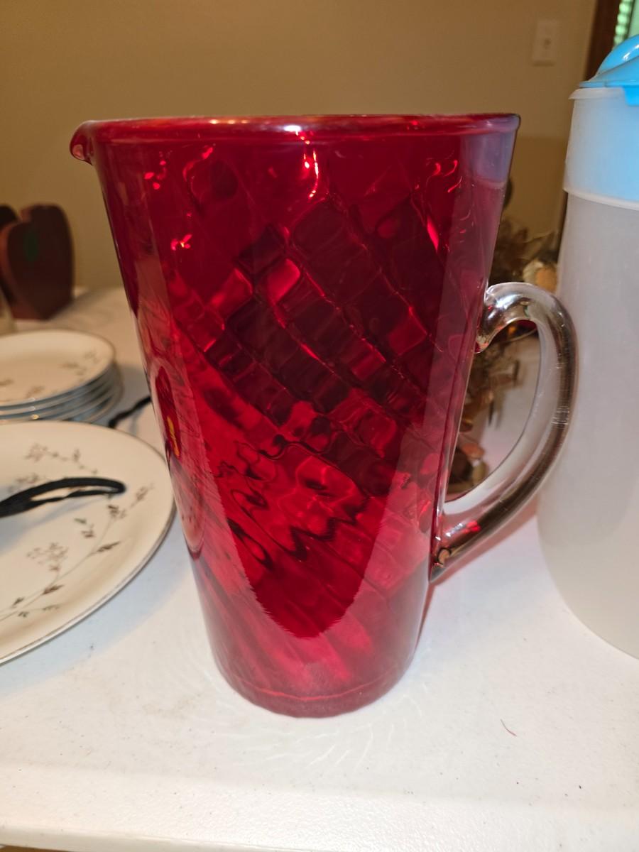 Red glass pitcher | EstateSales.org