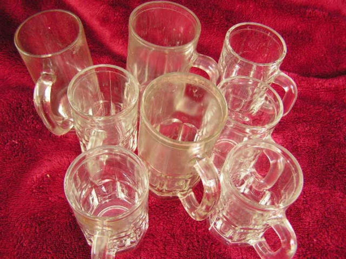 A group of small clear glass mugs. | EstateSales.org
