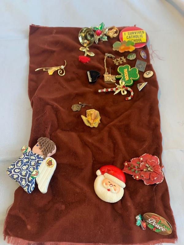 Assorted pins on cloth | EstateSales.org