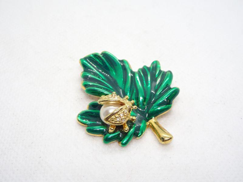Gold Lady Bug on a Emerald Green Leaf Brooch | EstateSales.org
