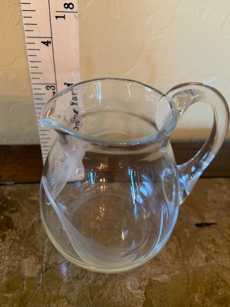 Small glass pitcher | EstateSales.org