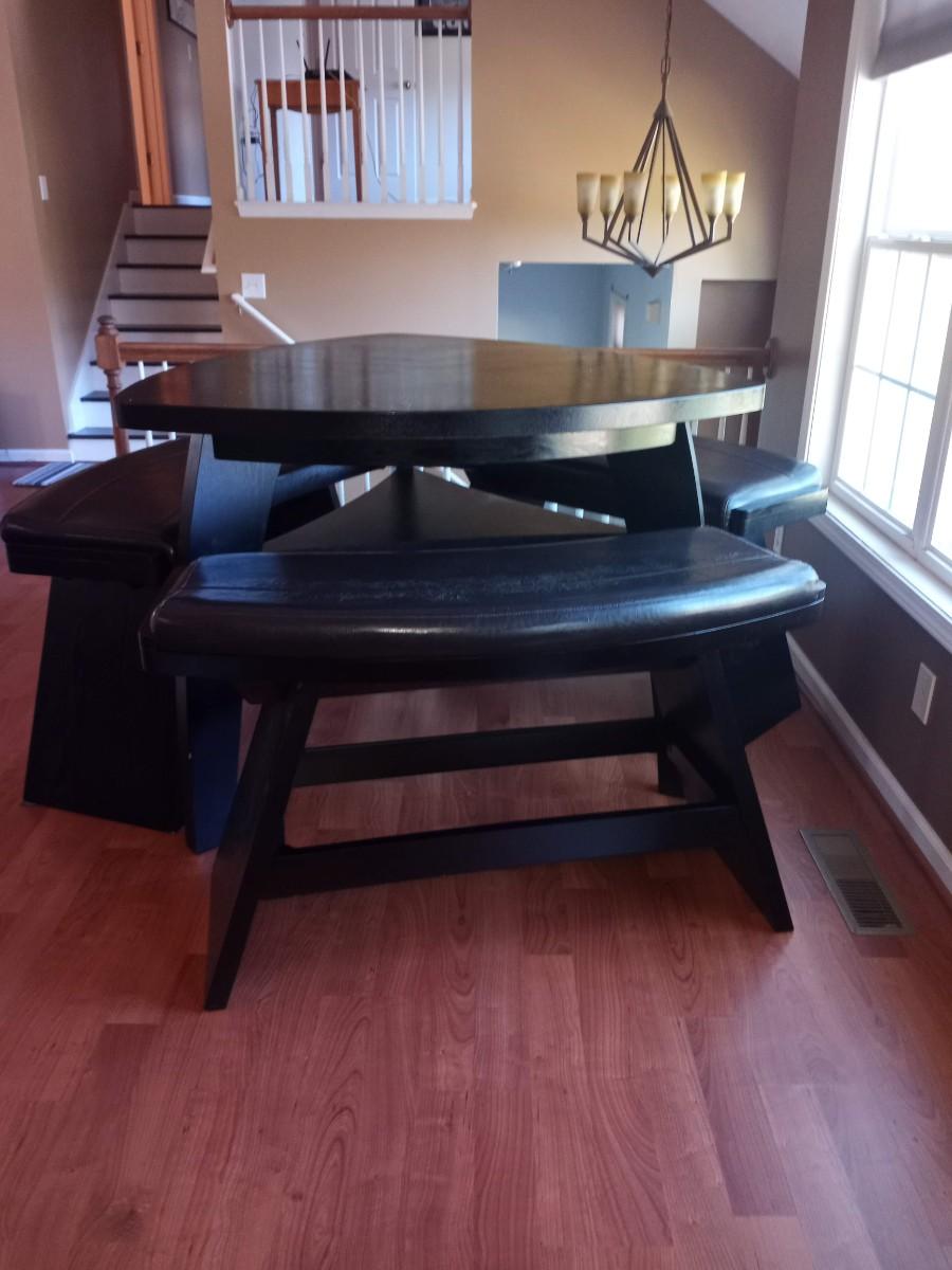 Triangle dining table and 2 curved bench seats | EstateSales.org