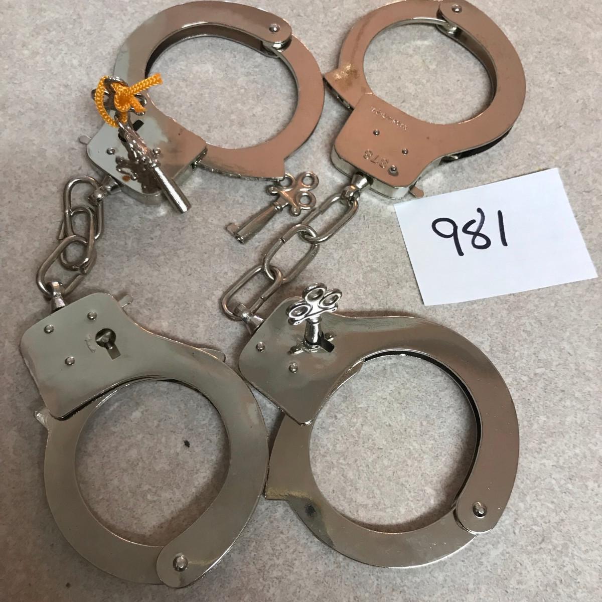 Set of two hand cuffs with keys | EstateSales.org
