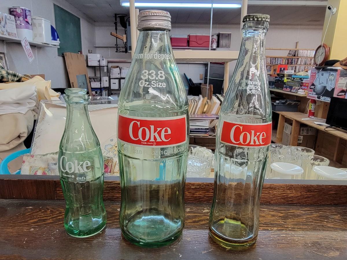 3 empty coke glass bottles | EstateSales.org