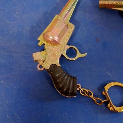 LOT 58 SIX VINTAGE CAP GUN KEY CHAINS | EstateSales.org
