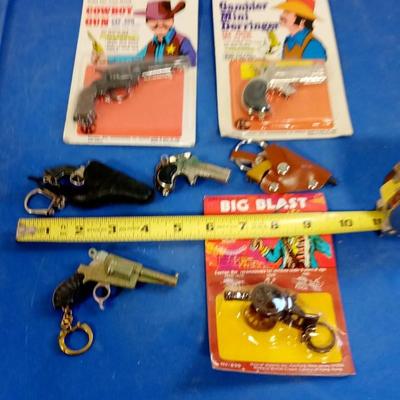 LOT 25 SEVEN DIFFERENT CAP FIRING KEY CHAIN GUNS | EstateSales.org
