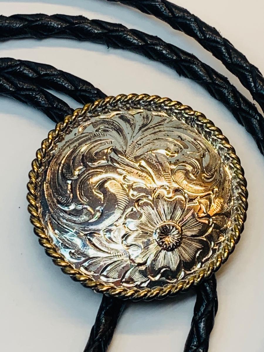 LOT 104: Silver & Gold Plated Belt Buckles & Bolo Tie | EstateSales.org