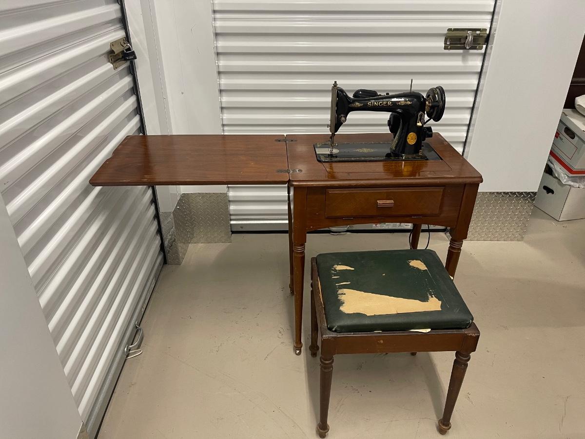 Vintage singer sewing machine, cabinet and. Bench. Includes box of ...