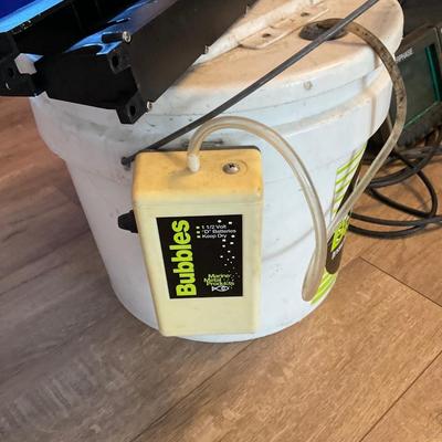 Interphase fish finder, cool bubbles bucket and black fishing pole ...