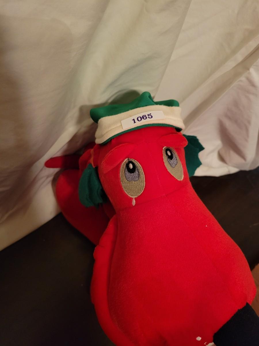 Large red Dog (Clifford?) wearing holiday hat | EstateSales.org