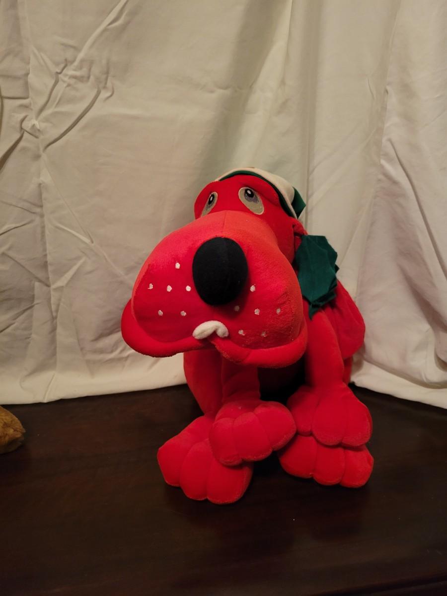 Large red Dog (Clifford?) wearing holiday hat | EstateSales.org
