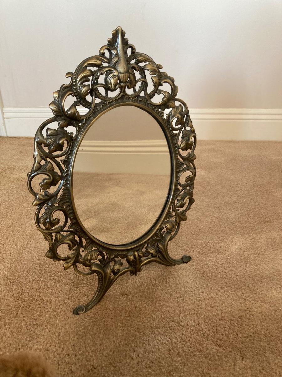 Ornate vintage metal vanity mirror. | EstateSales.org
