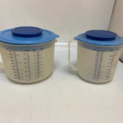 Pair of Large Plastic Measuring Cups with Lids 9c & 5c | EstateSales.org