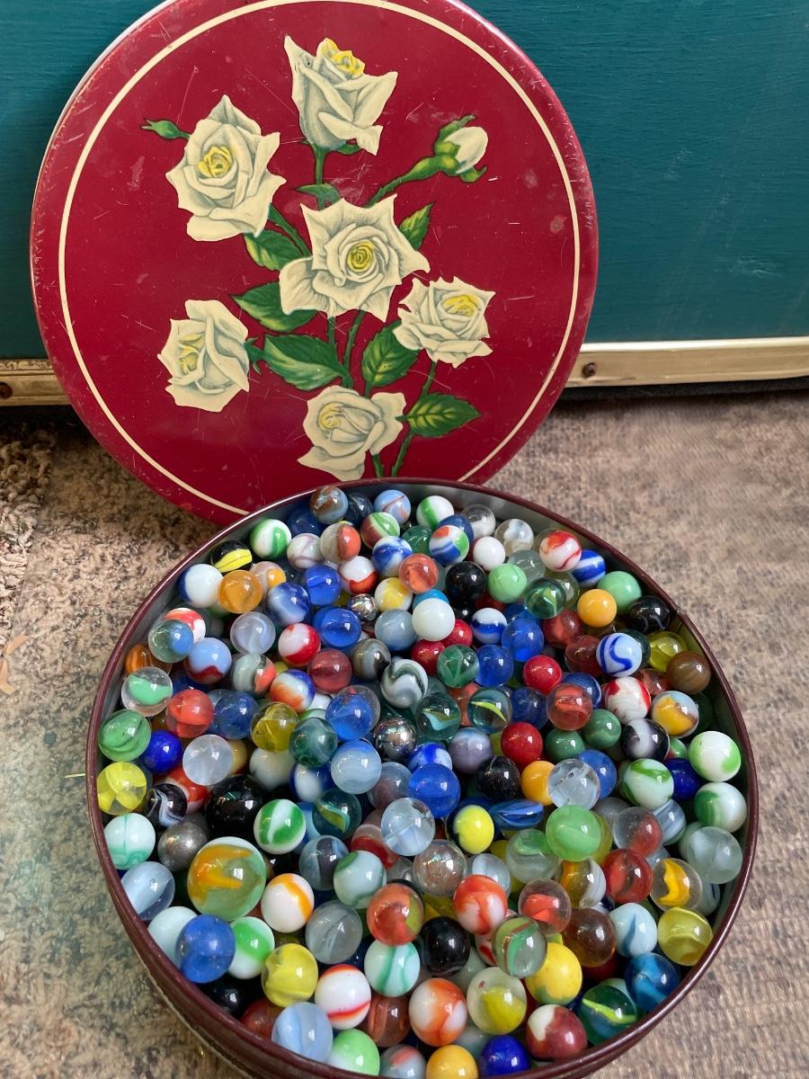 Large tin of marbles | EstateSales.org