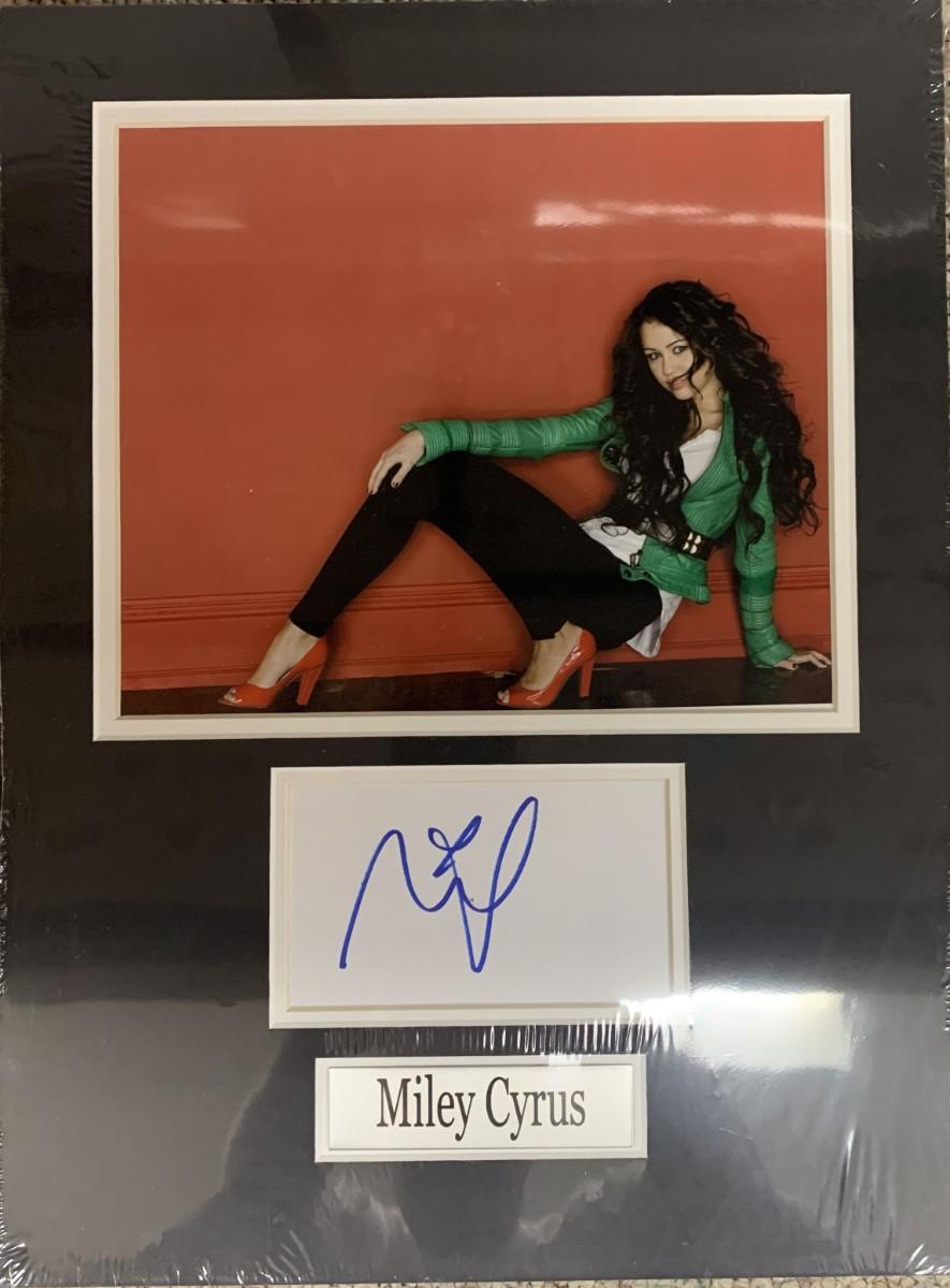 Miley Cyrus signature cut and photo collage | EstateSales.org