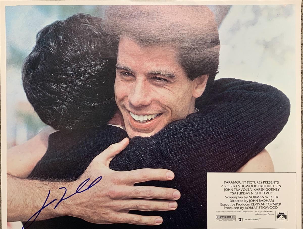 John Travolta signed lobby card | EstateSales.org