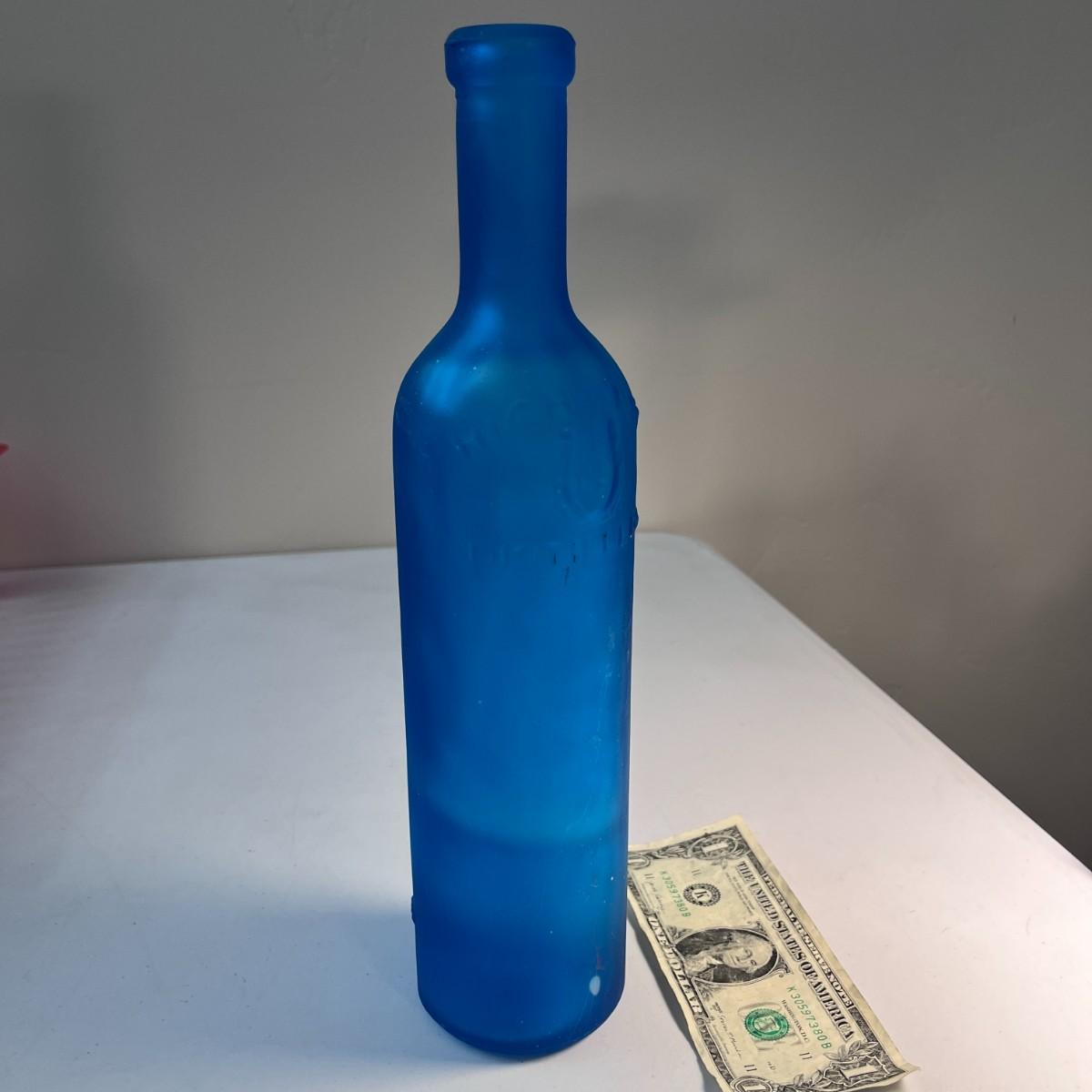 TALL BLUE HIGH WEST DISTILLERY BOTTLE | EstateSales.org