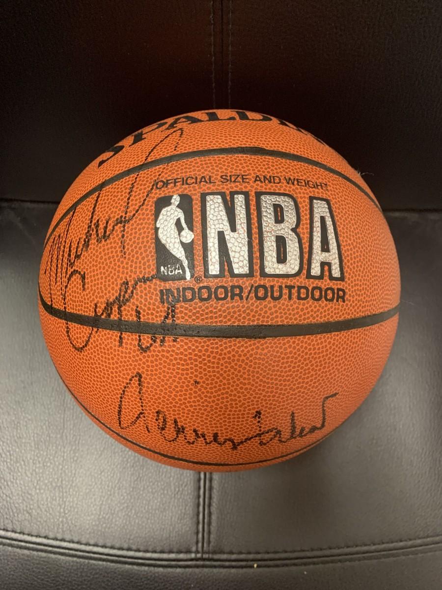 Jerry West and Michael Cooper signed basketball | EstateSales.org