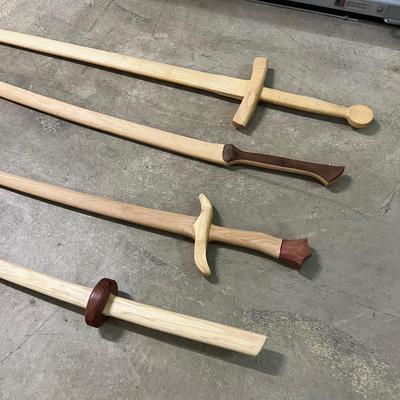 (4) Long Wood Swords | EstateSales.org