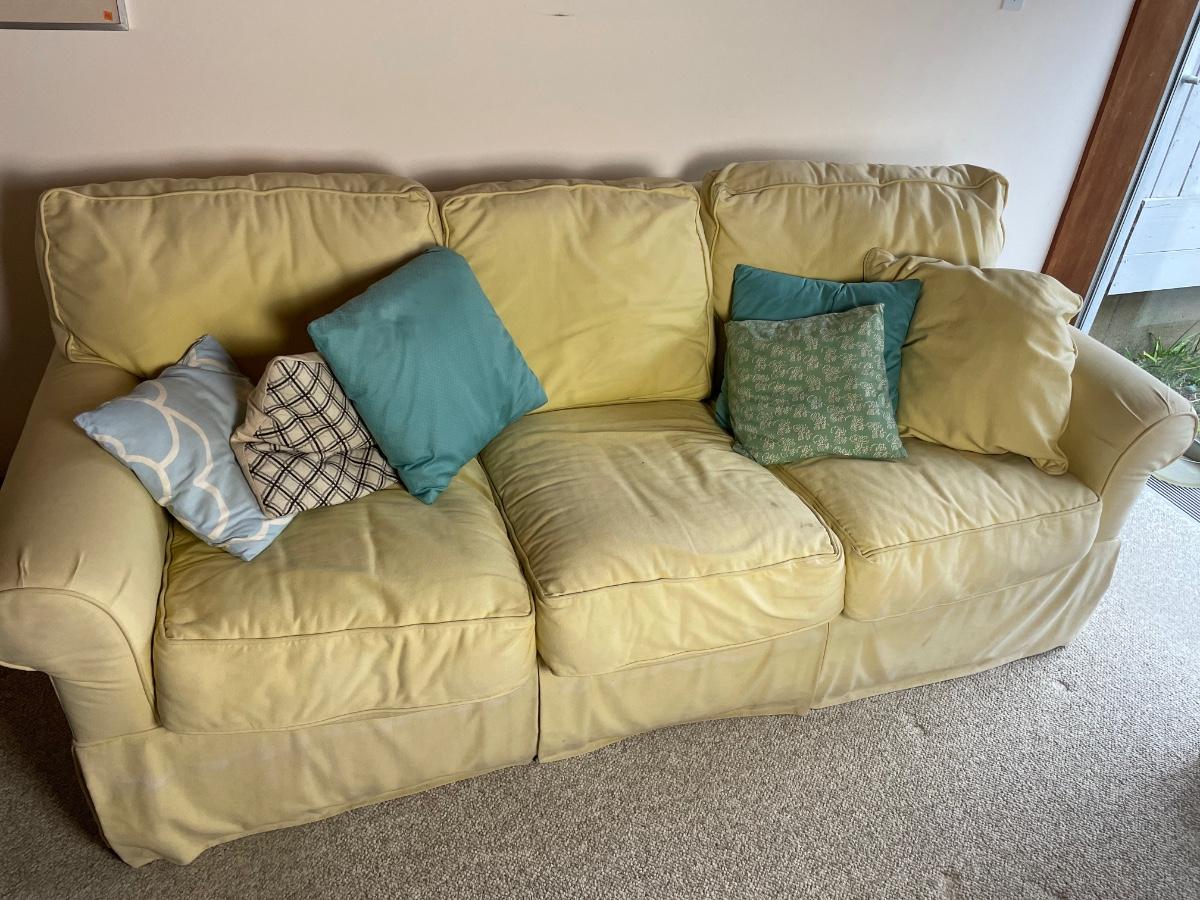 Yellow couch. | EstateSales.org