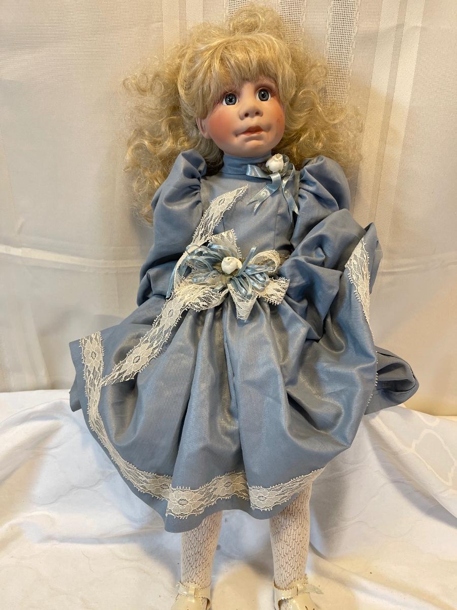 Porcelain doll with cloth body | EstateSales.org