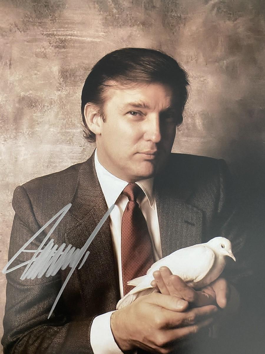 Donald Trump with a dove signed photo | EstateSales.org