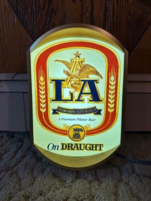 LIGHTED LA BEER SIGN AND A MILLER MIRRORED SIGN | EstateSales.org